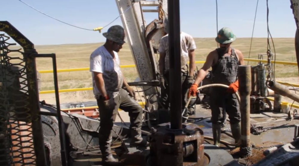 Roughnecks at Work - Drilling Rig Pipe Connection